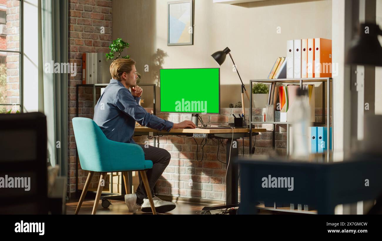 Young Handsome Man Working from Home on Desktop Computer with Green ...