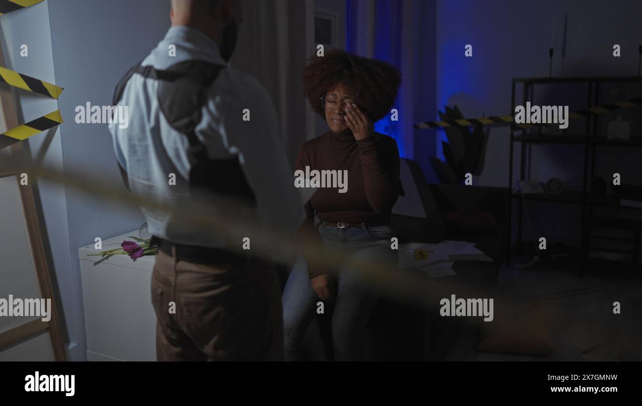 A woman and man investigator examining evidence at an indoor crime ...