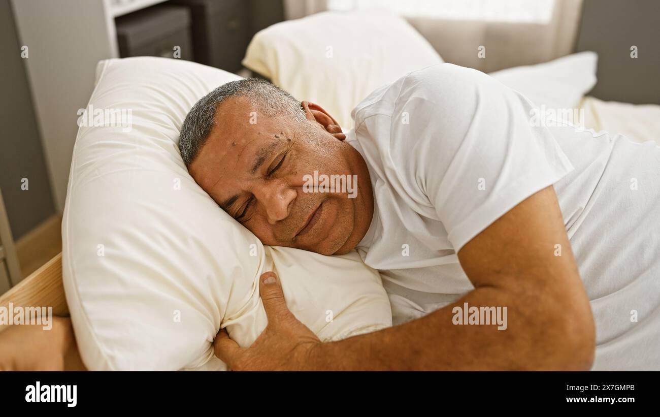 Mature hispanic man sleeping peacefully in a cozy bedroom setting ...