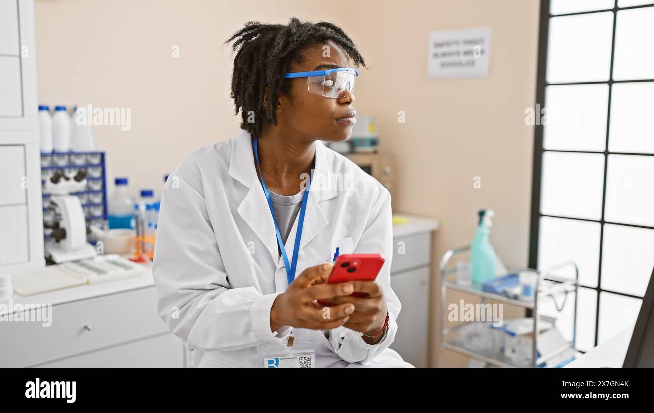 African-american scientist with dreadlocks wearing lab coat and ...