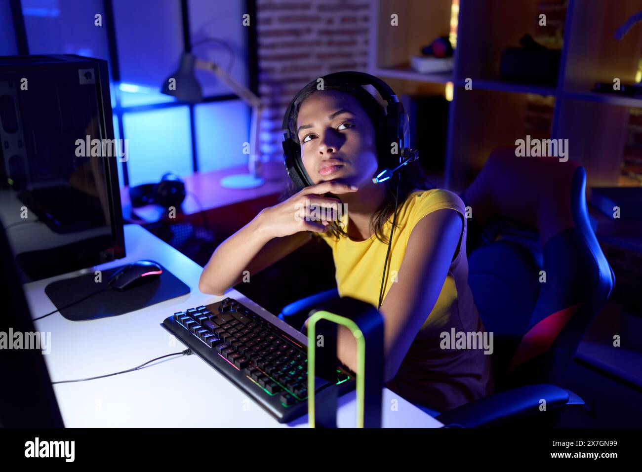 Young african american woman streamer sitting on table with doubt ...