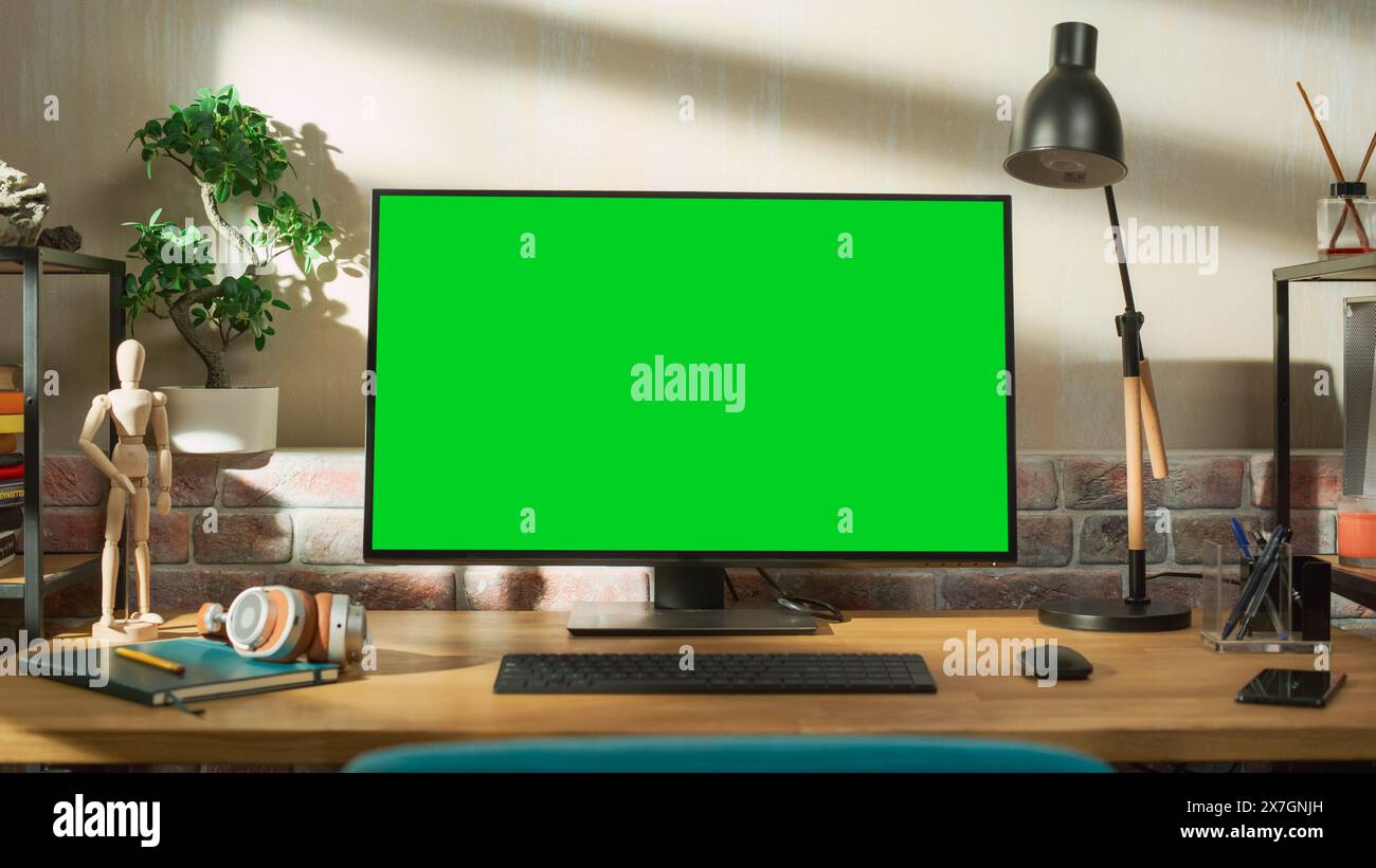 Desktop Computer Monitor Standing on a Table with a Green Screen ...