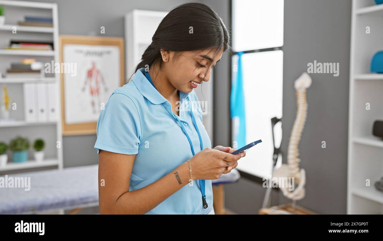 An indian woman in a clinic engages with her smartphone amidst medical ...
