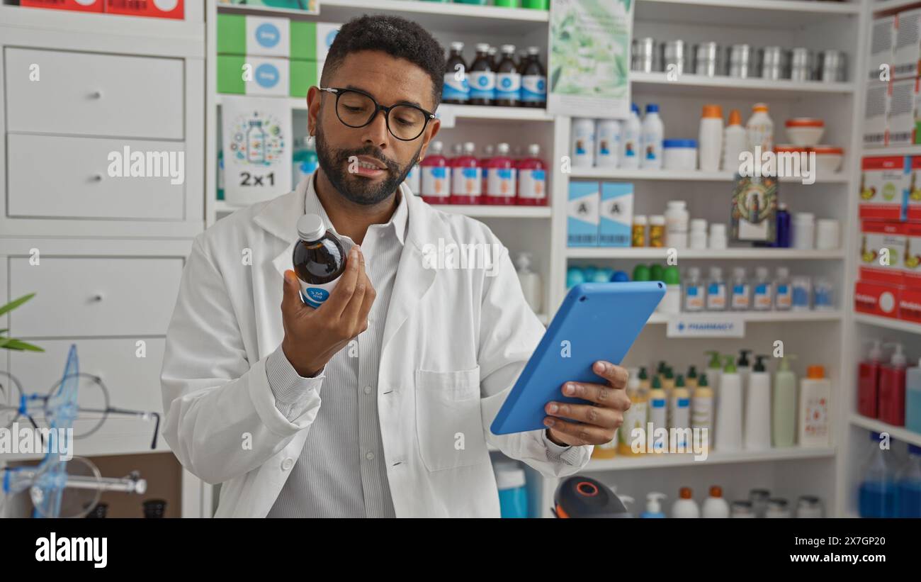 Handsome african american male pharmacist analyzing a medicine bottle ...