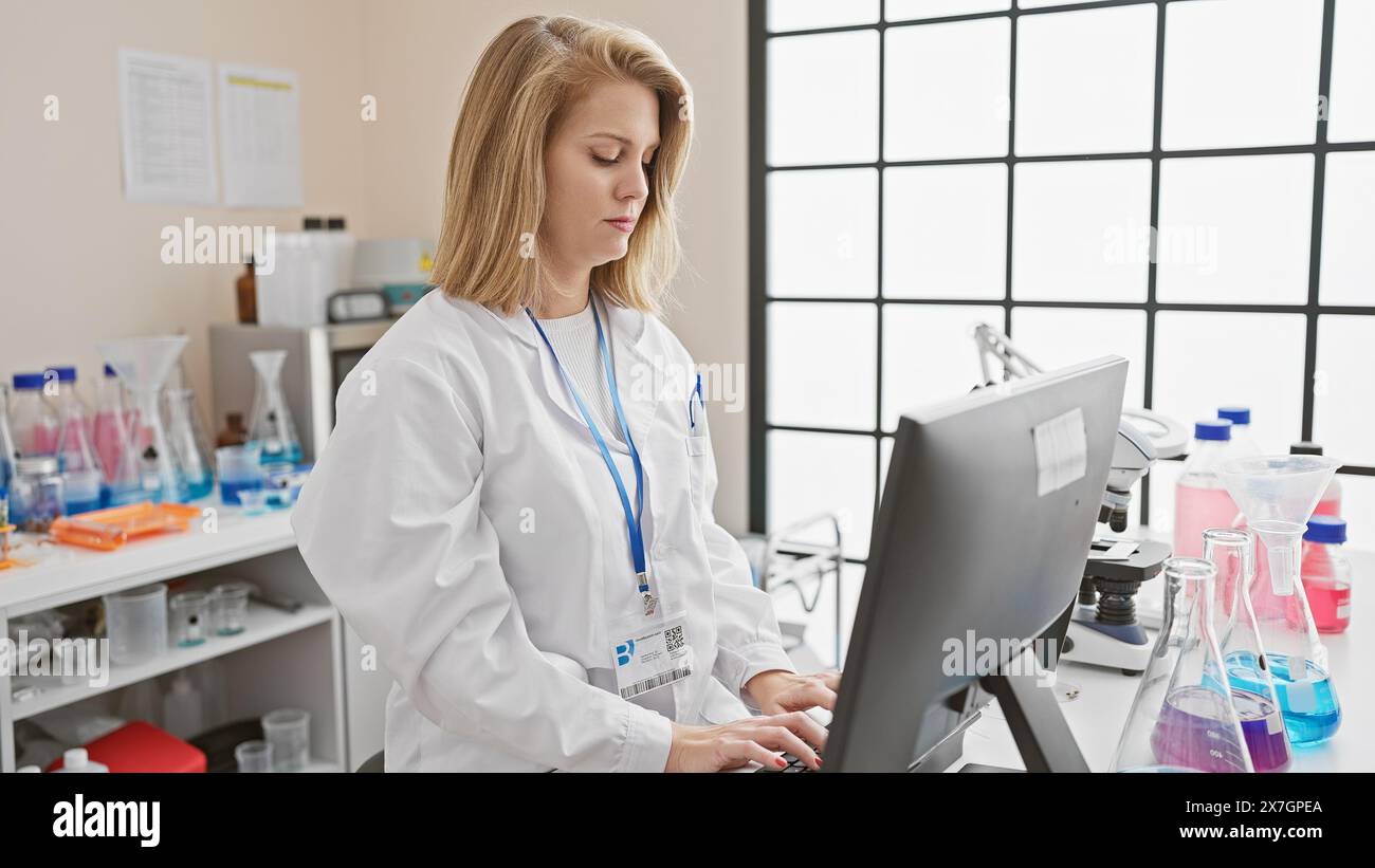 Focused woman scientist using computer in modern laboratory with equipment Stock Photo - Alamy