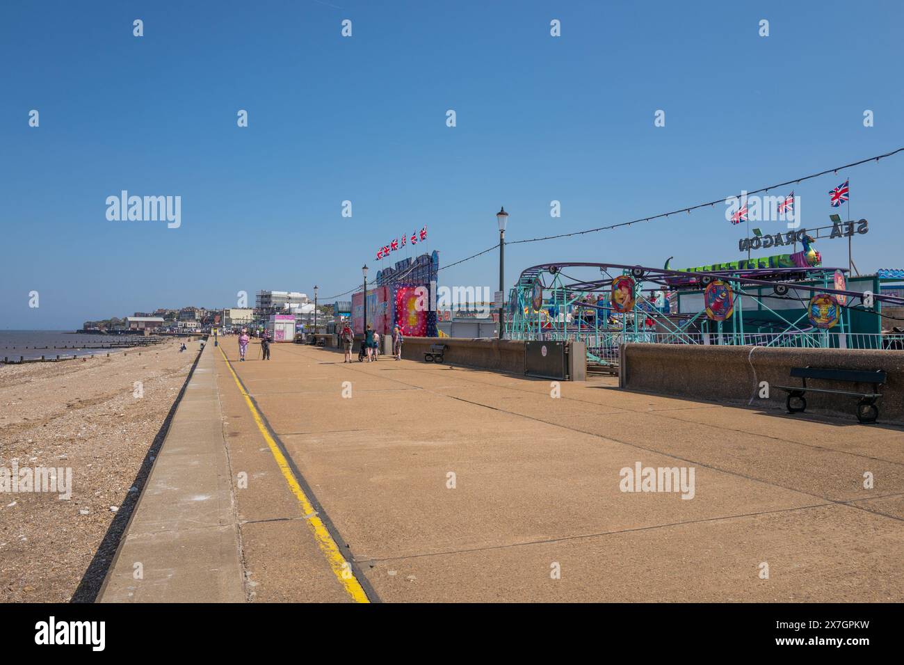 Holiday makers walking the concrete sea wall and promenade at the North ...