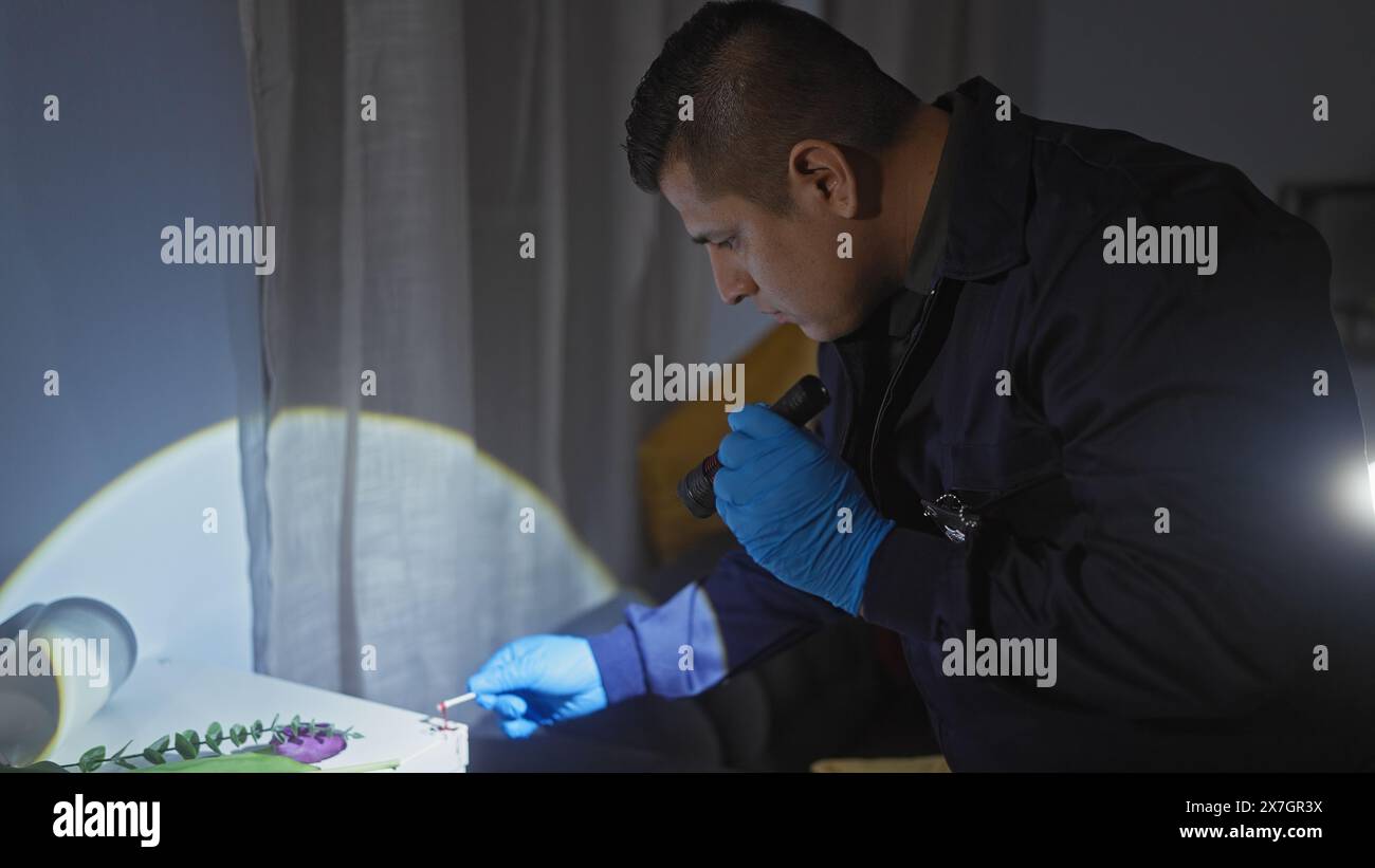 Hispanic man in uniform examining evidence at an indoor crime scene ...