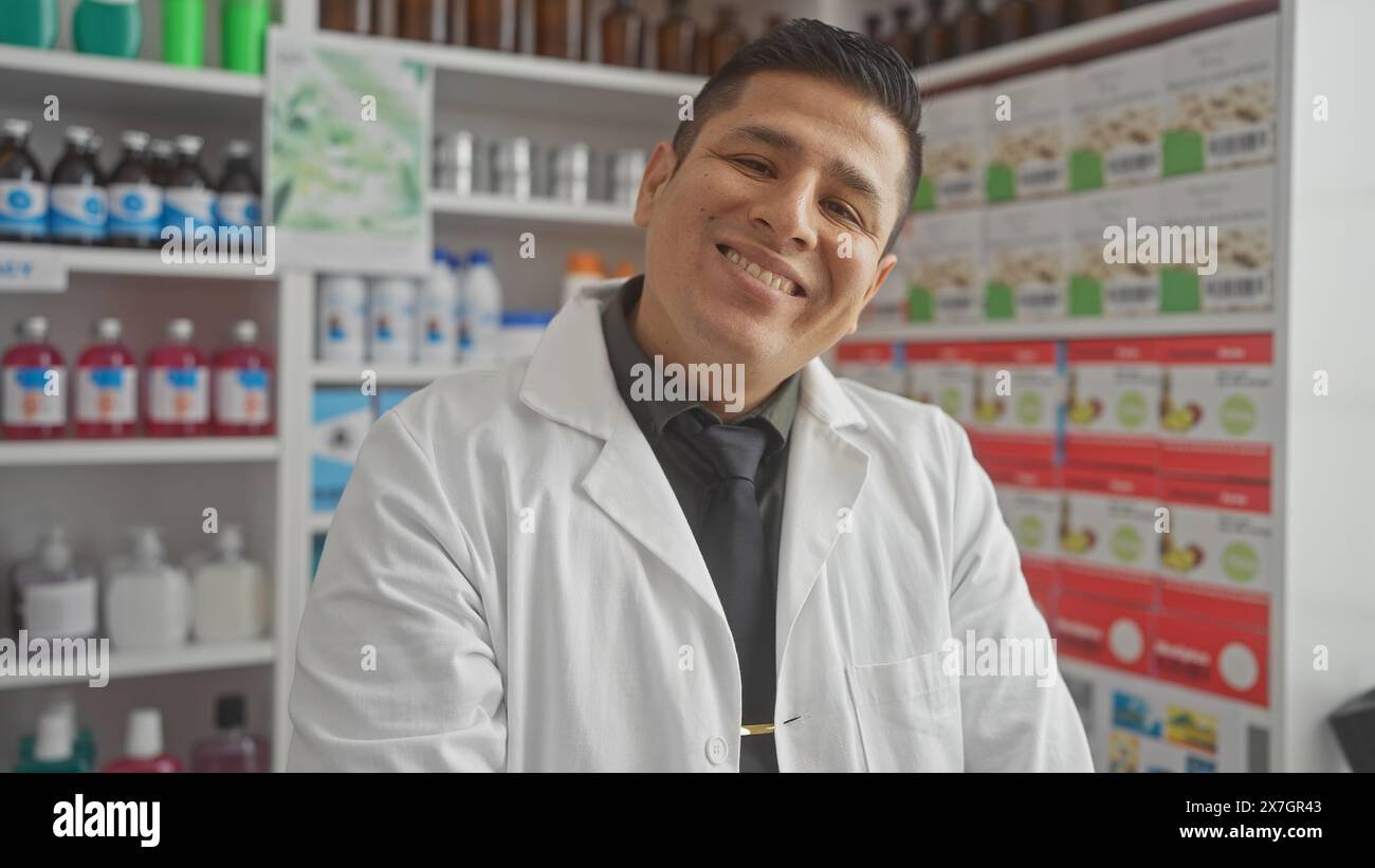 A cheerful hispanic man in pharmacist attire posing in front of ...