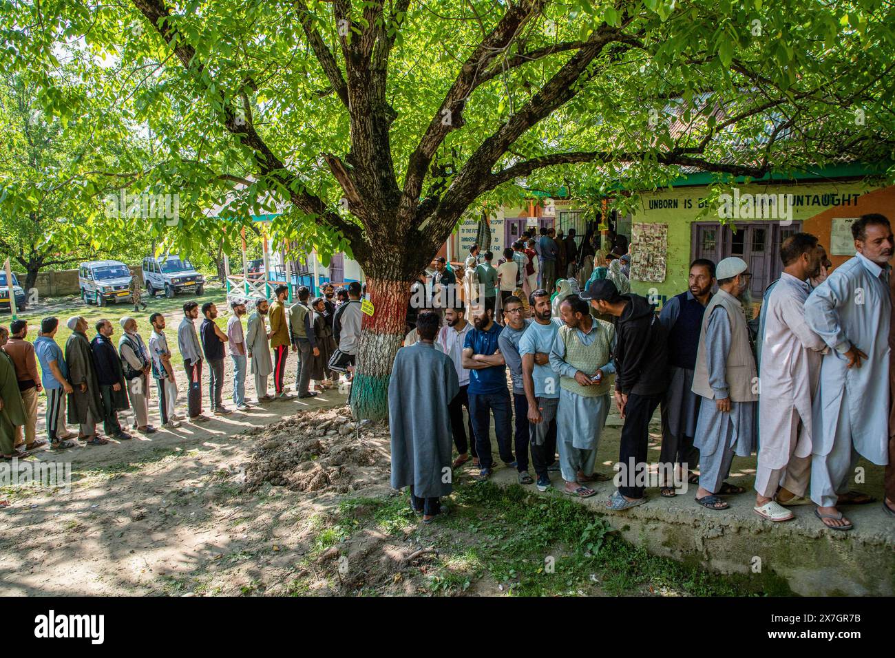 Kashmiri voters wait in a queue to cast their ballots outside a polling ...
