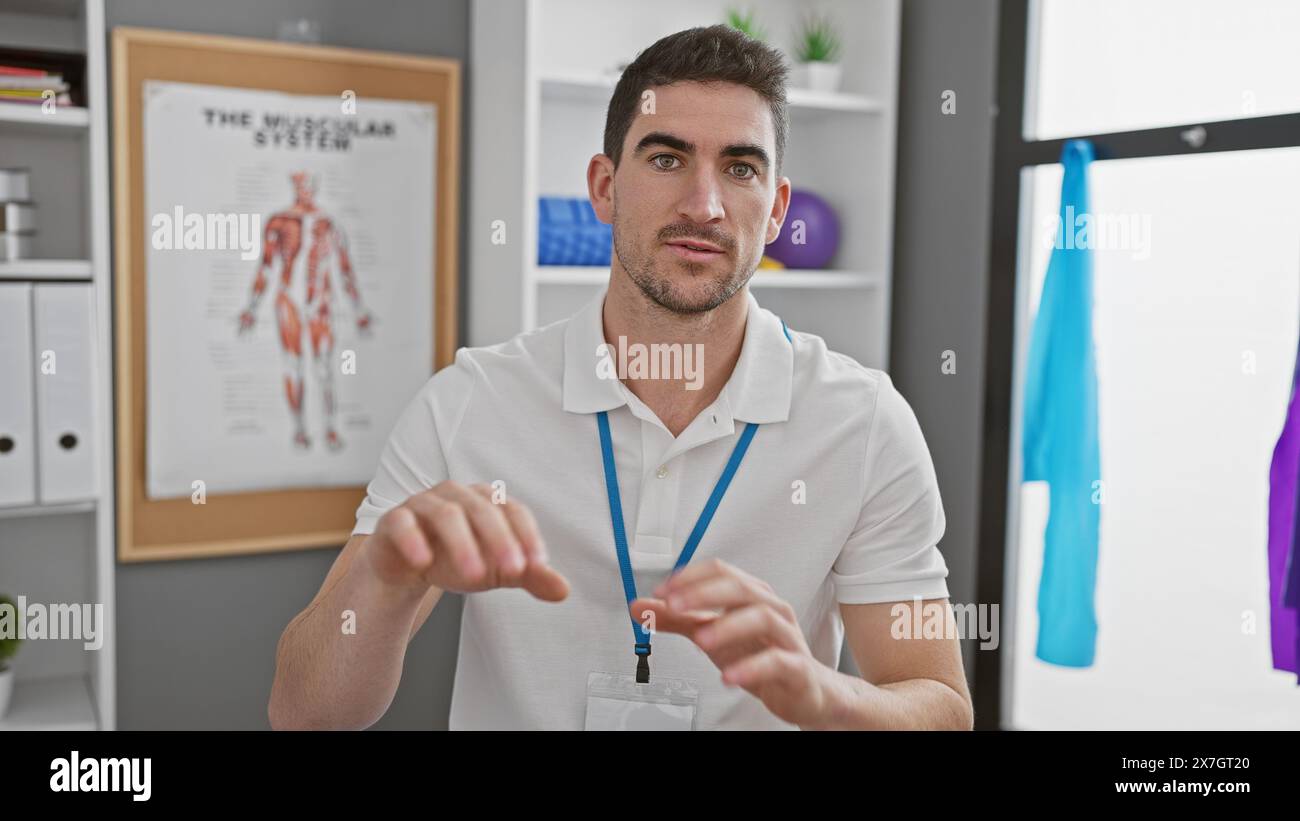 Handsome hispanic male therapist in a rehabilitation clinic, wearing a ...