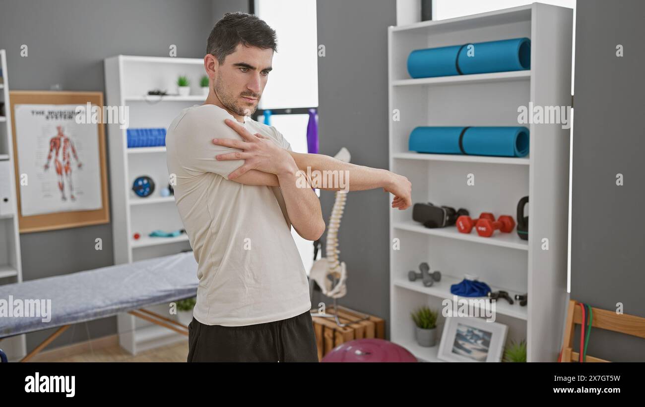 Young hispanic man physiotherapist stretching hi-res stock photography and images - Alamy