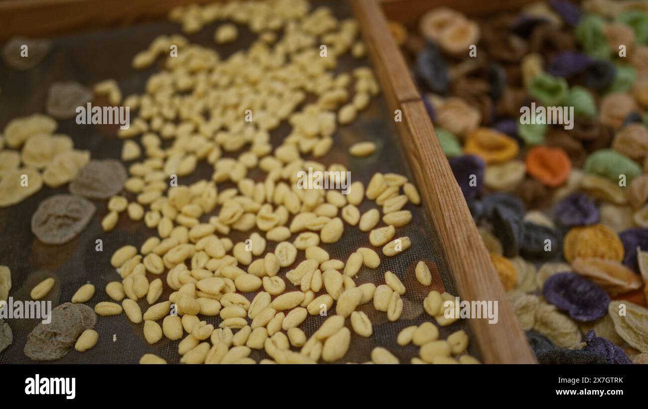 An outdoor display of traditional orecchiette pasta drying in bari ...