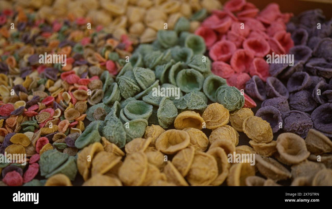 A vibrant display of colorful traditional italian pasta outdoors in ...