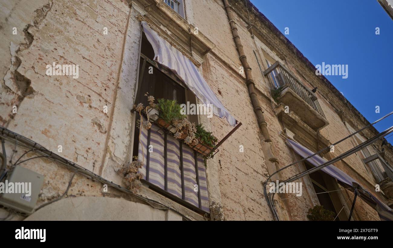 Rustic exterior of an old building in bari, italy with weathered walls ...