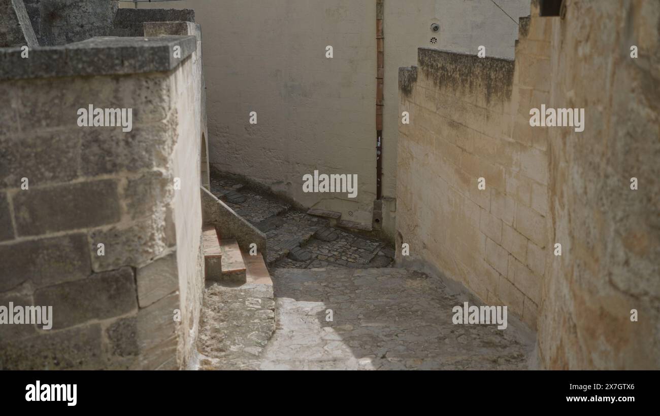 Narrow, ancient stone alleyway in matera, basilicata, italy, with worn ...
