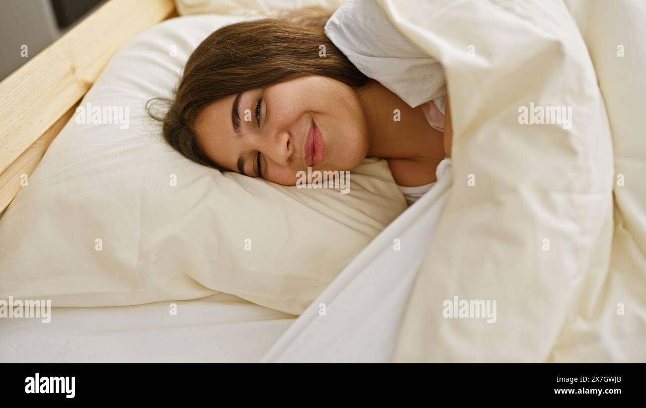 A young hispanic woman rests peacefully in a bedroom setting, exuding a ...
