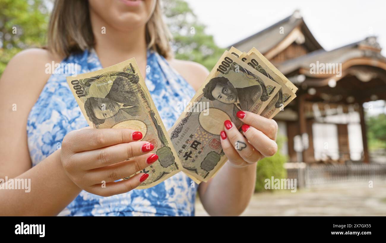 Caucasian young woman's hands counting wealth of japan yen banknotes at ...