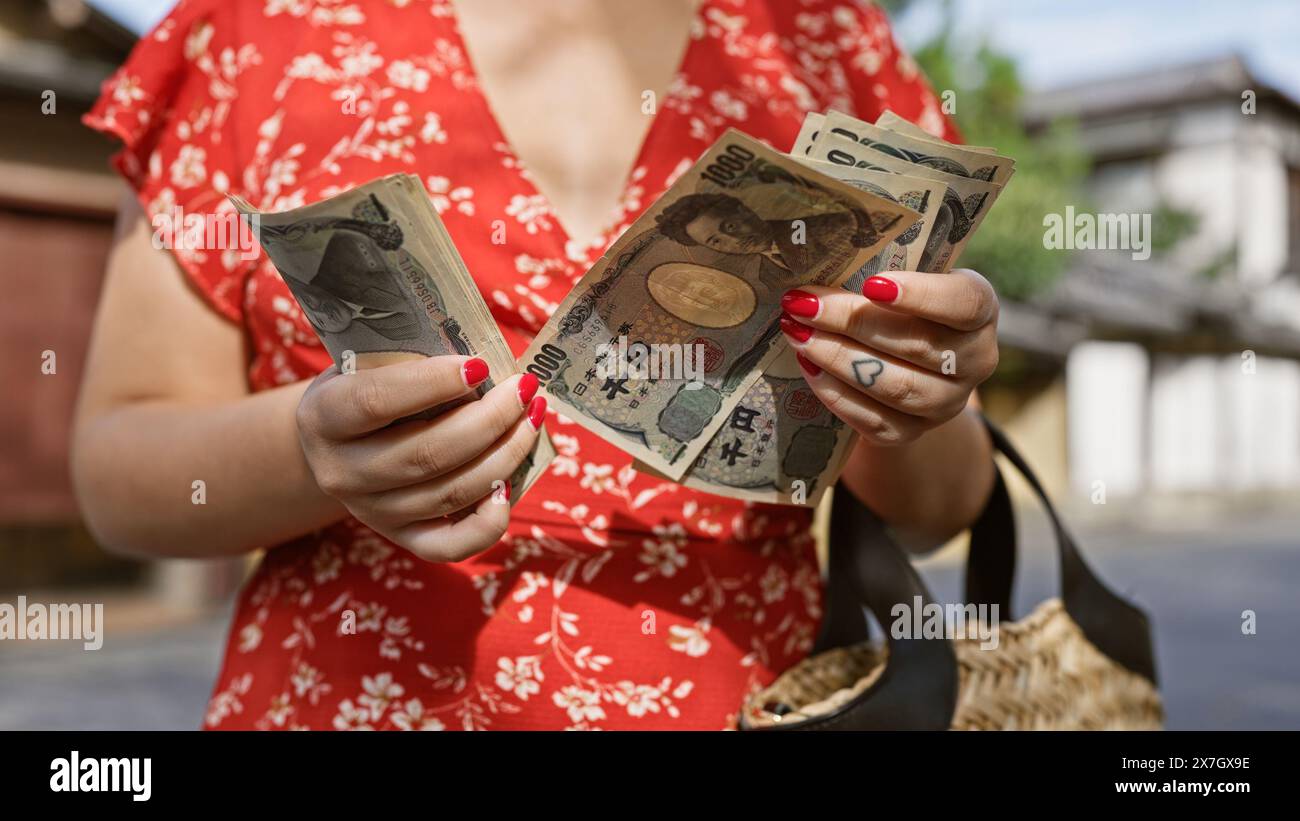Young woman's hands, busy counting yen banknotes in the traditional ...