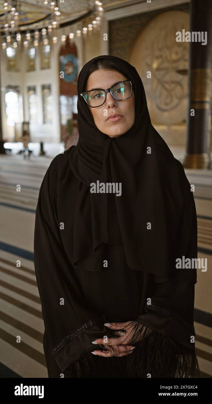 Young hispanic brunette woman wearing hijab inside a doha mosque with ...
