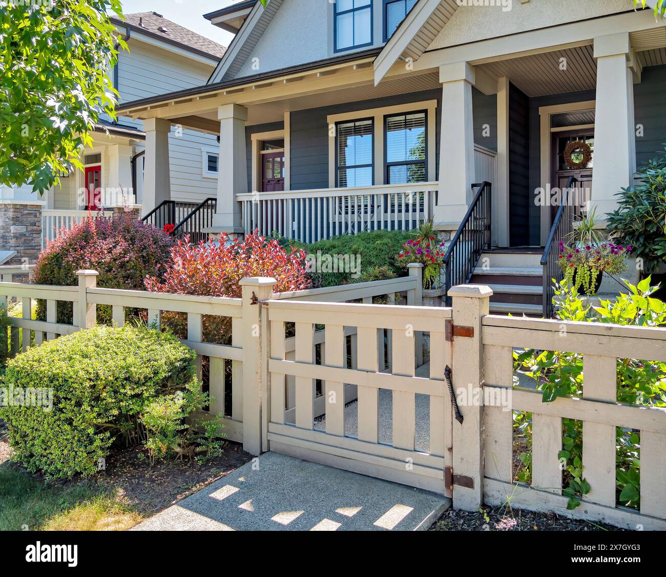 The porch and entrance door of nice residential house with wooden gate ...