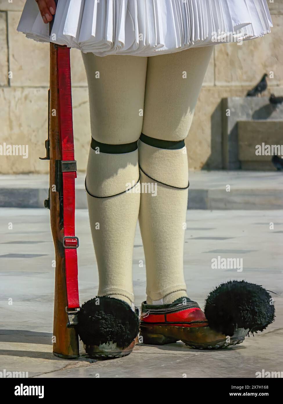 Greek guard in traditional historical uniform standing to attention ...