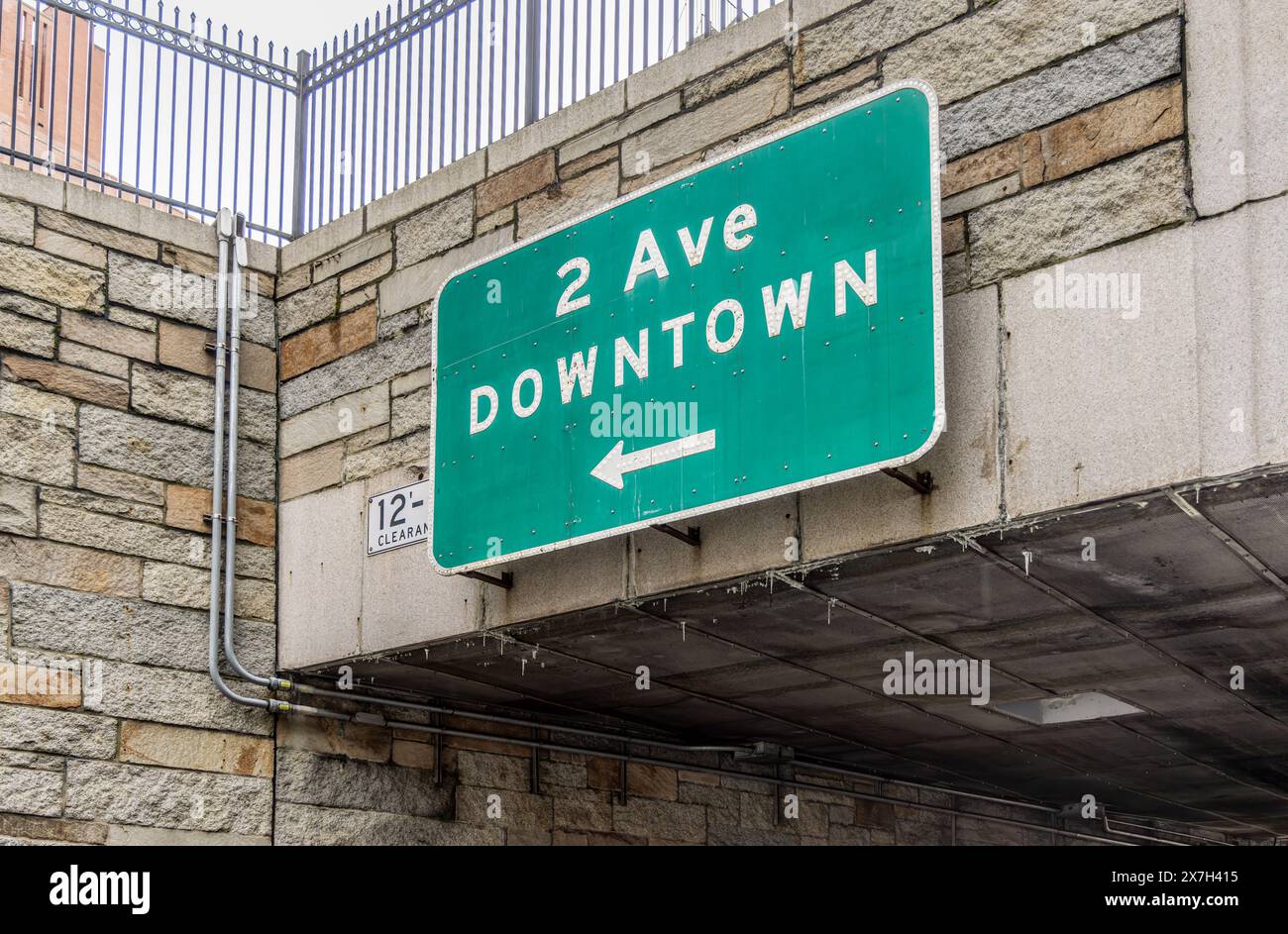 large green and white traffic sign on a underpass in midtown manhattan ...