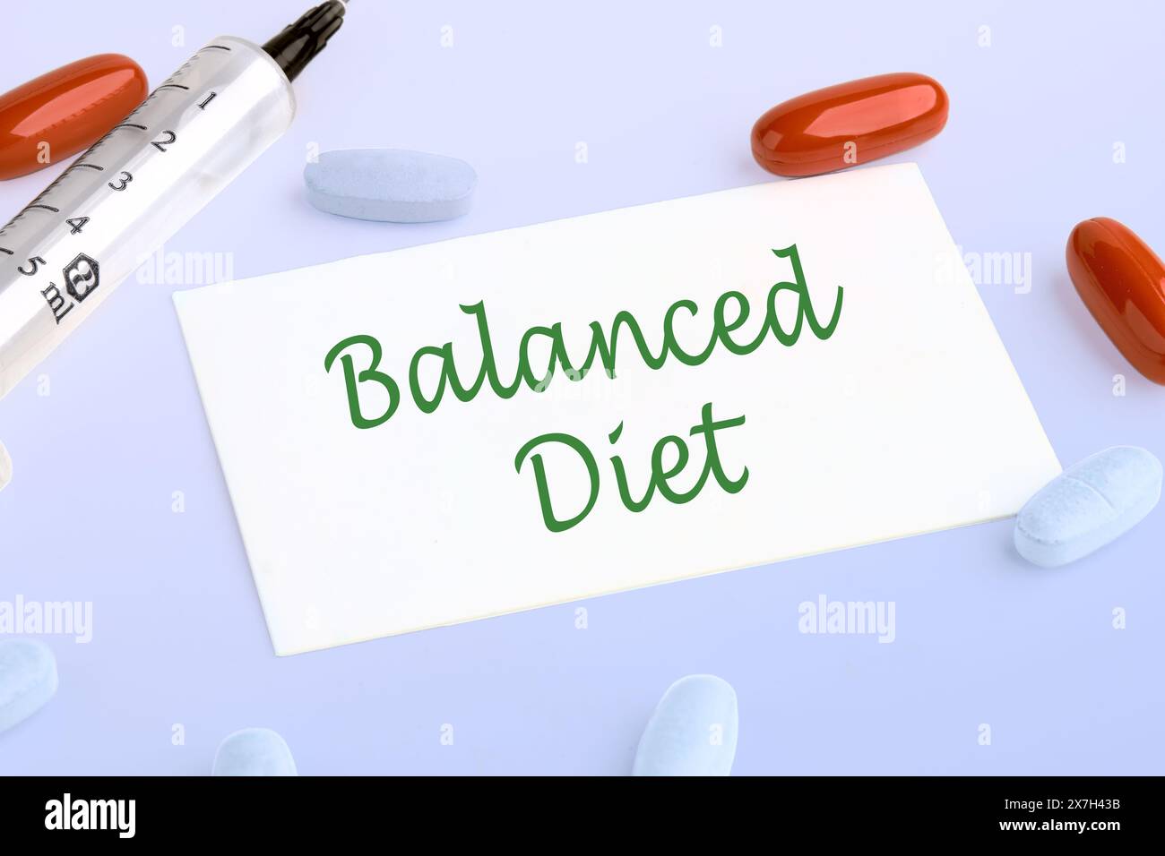 Balanced food. Balanced Diet text written on the business card next to ...