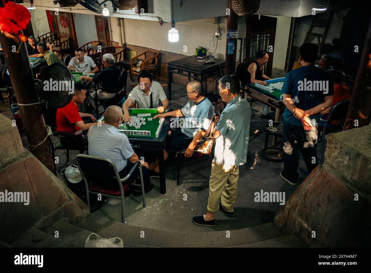 Lively Gathering of Men Playing Mahjong in a Traditional Chinese ...