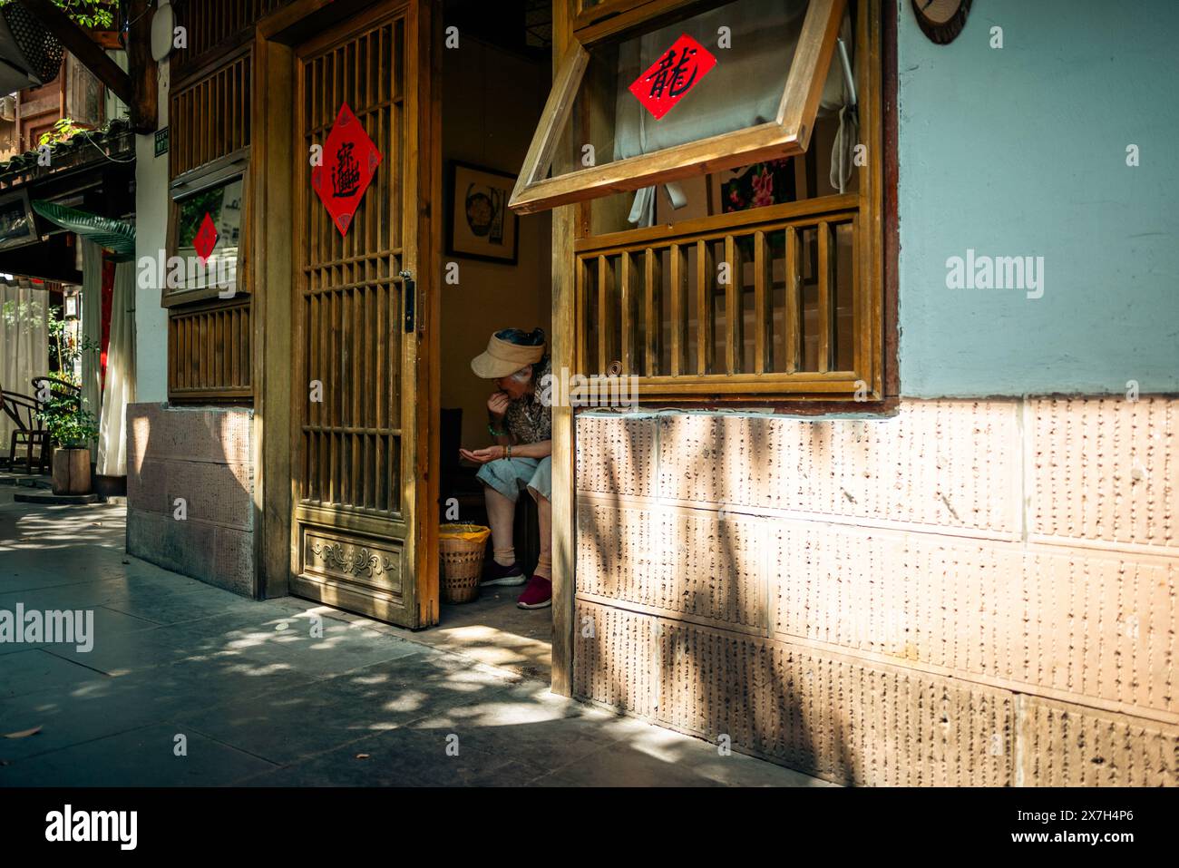 Elderly Woman Sitting inside a Traditional Chinese House Stock Photo ...