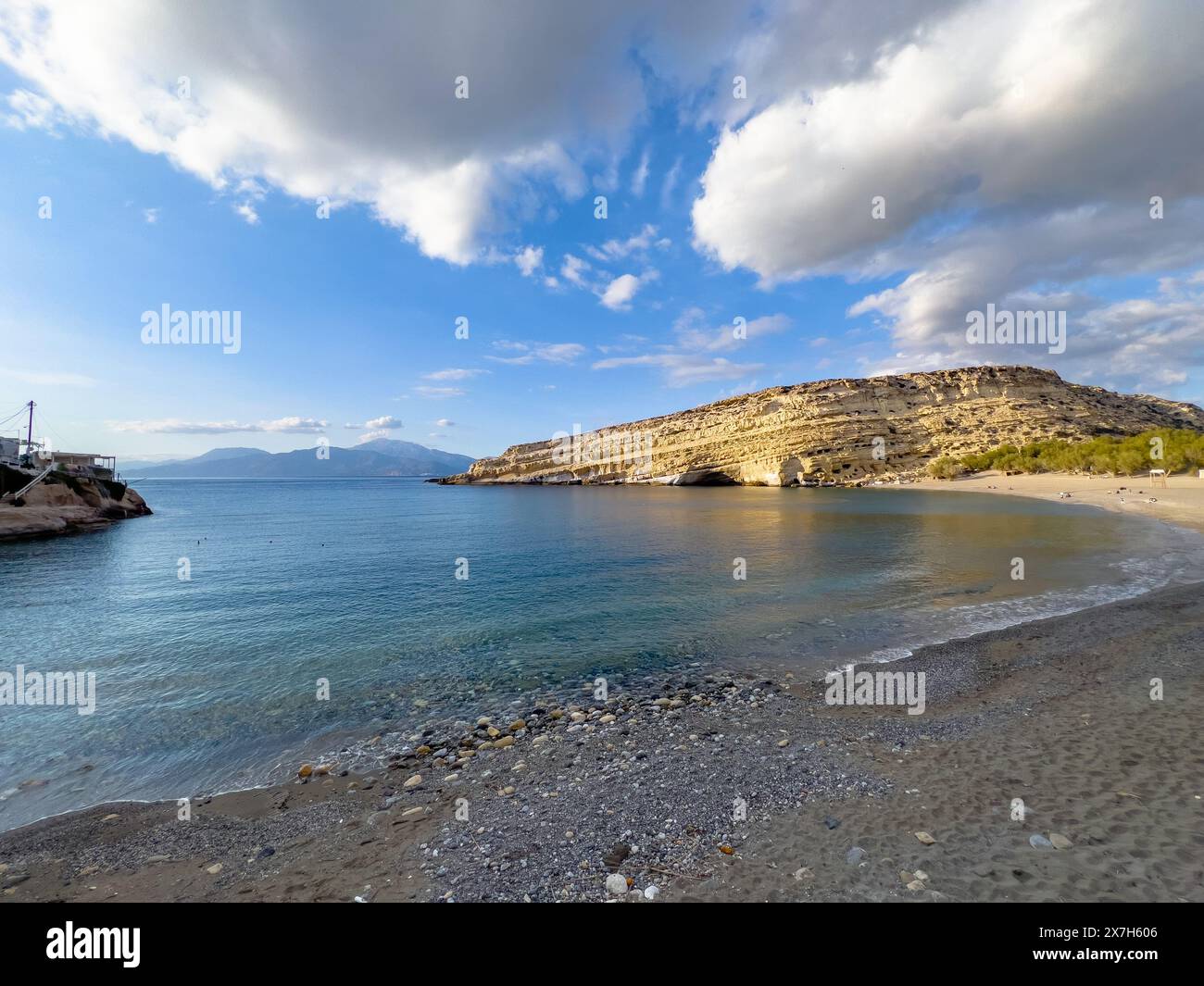 Matala beach with caves on the rocks that were used as a roman cemetery ...