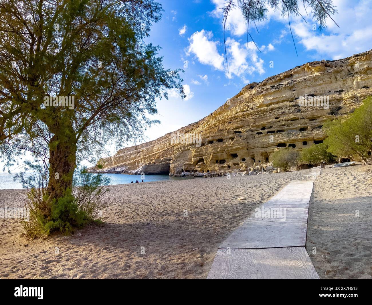 Matala beach with caves on the rocks that were used as a roman cemetery ...