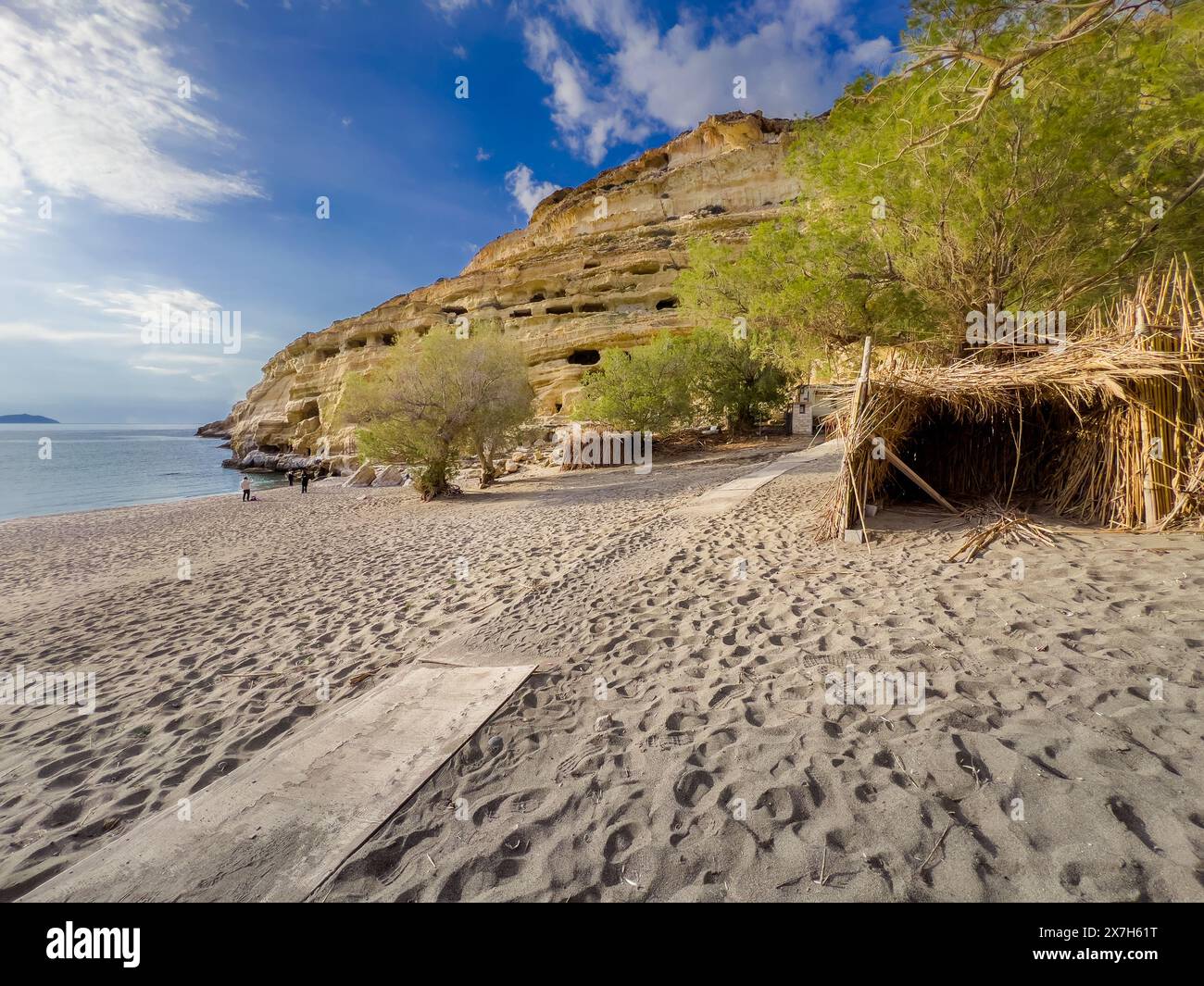 Matala beach with caves on the rocks that were used as a roman cemetery ...