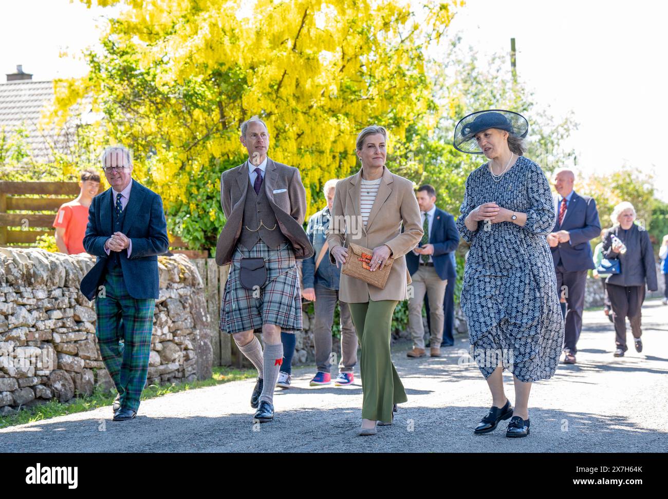 The Duke and Duchess of Edinburgh walk through the village with Lord ...