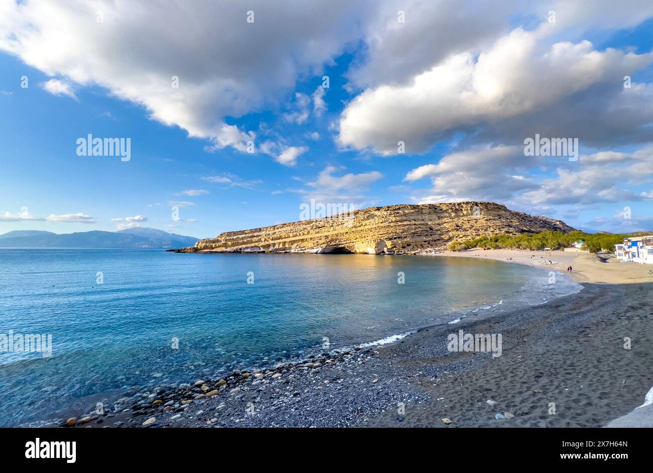 Matala beach with caves on the rocks that were used as a roman cemetery ...