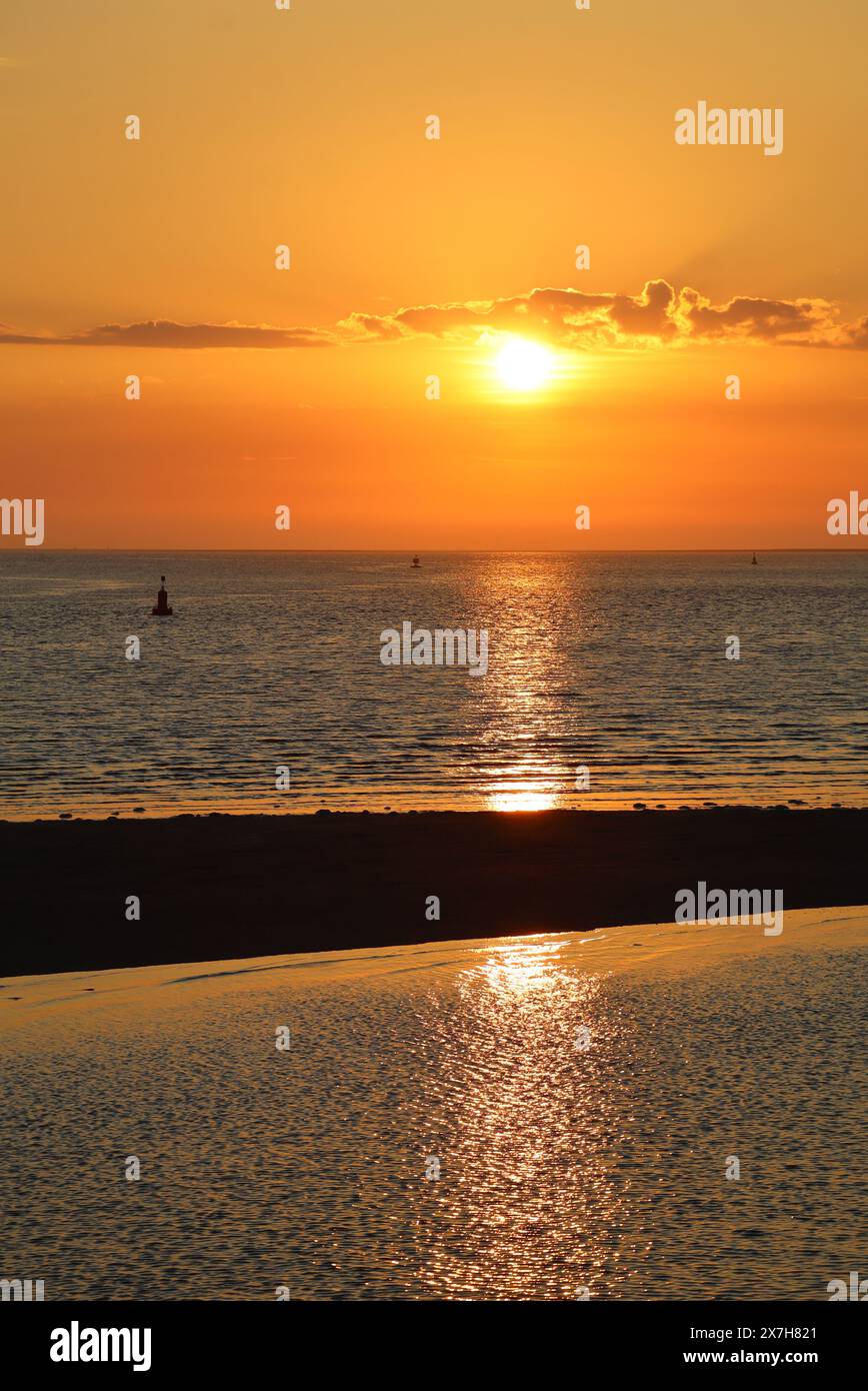 Golden sunset seen from River Wyre shore footpath at Knott End-on-Sea ...