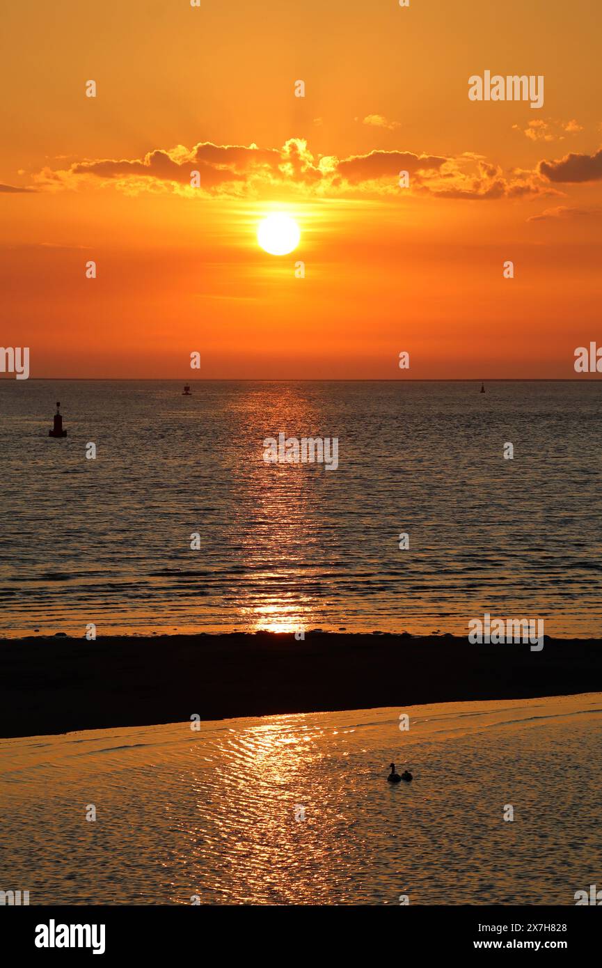 Golden sunset seen from River Wyre shore footpath at Knott End-on-Sea ...
