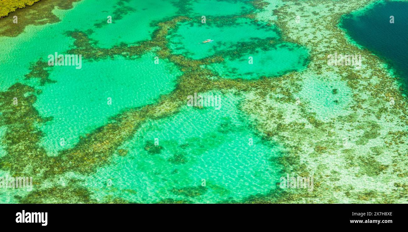 Bangka (boat) over coral, Chindonan Island, Calamian Islands, Coron ...