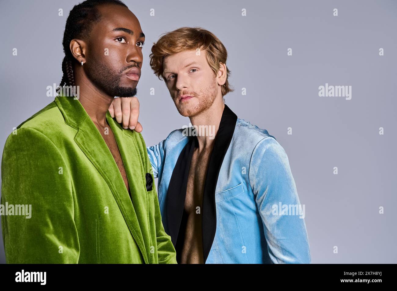 Two multicultural men in elegant dapper style standing together on gray ...