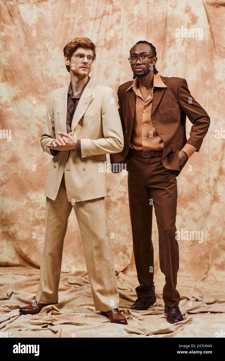 Two elegant multicultural men stand next to each other in front of a ...