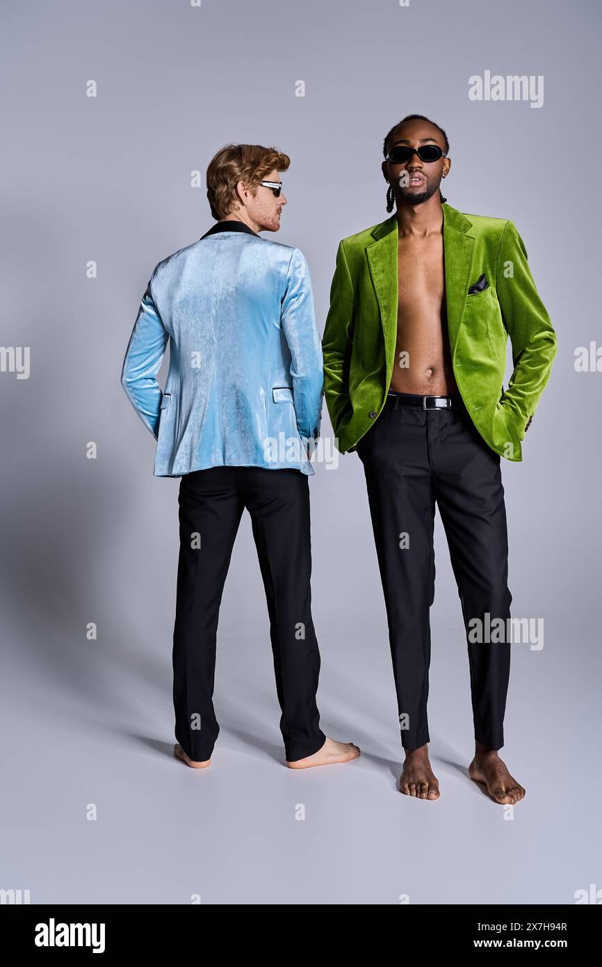 Two handsome, multicultural men in sharp suits stand side by side Stock ...