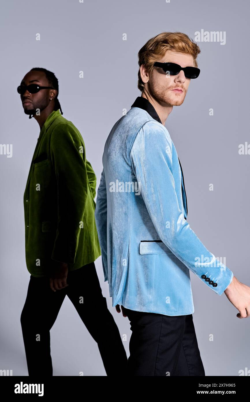 Two diverse men in dapper outfits walk confidently down an urban street ...