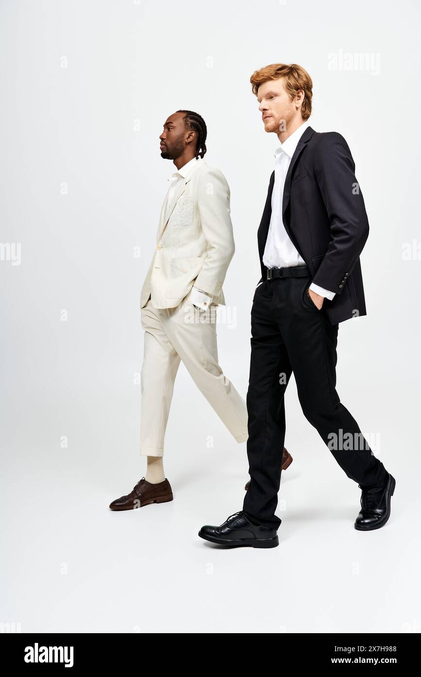 Two multicultural men in suits and ties walking side by side Stock ...