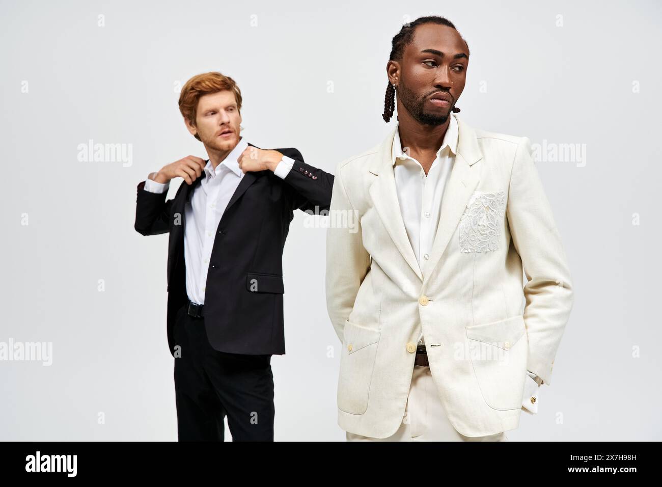 Two multicultural men in elegant suits strike a confident pose Stock ...