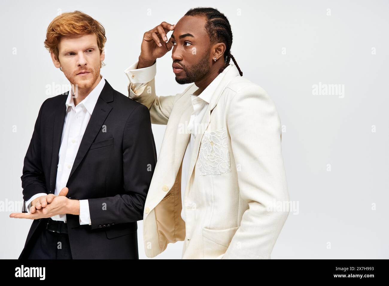 Two handsome multicultural men in stylish suits standing together Stock ...