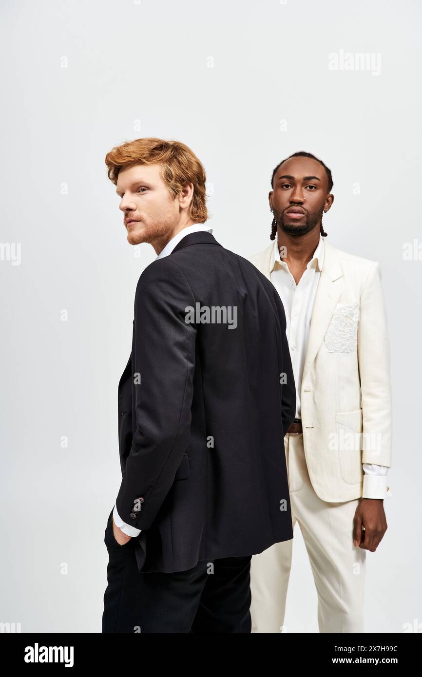 Two elegant multicultural men in suits standing side by side Stock ...