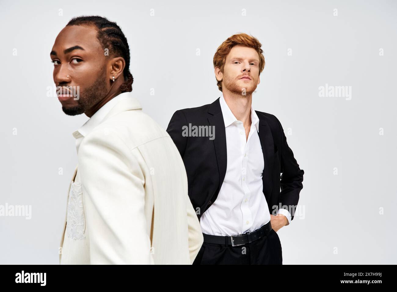Two handsome, multicultural men in elegant suits posing together Stock ...