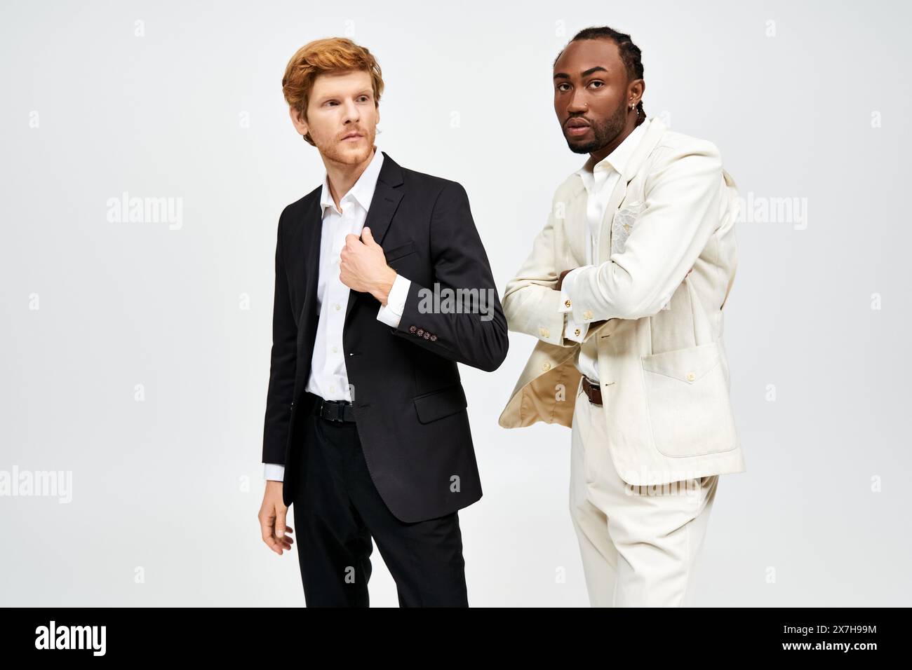 Two multicultural men in elegant suits stand side by side Stock Photo ...