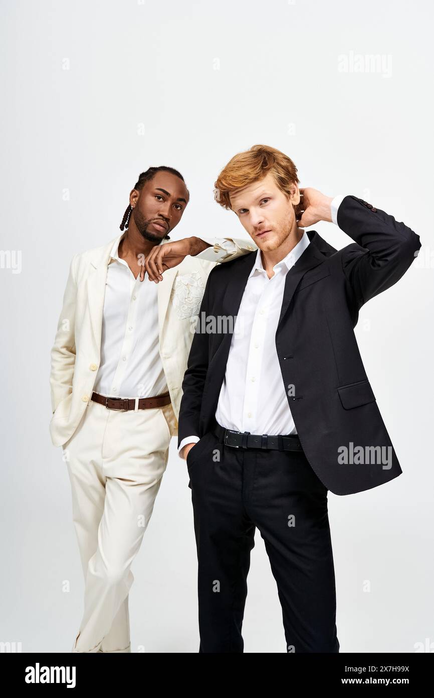 Two handsome men in tailored suits stand elegantly side by side Stock ...