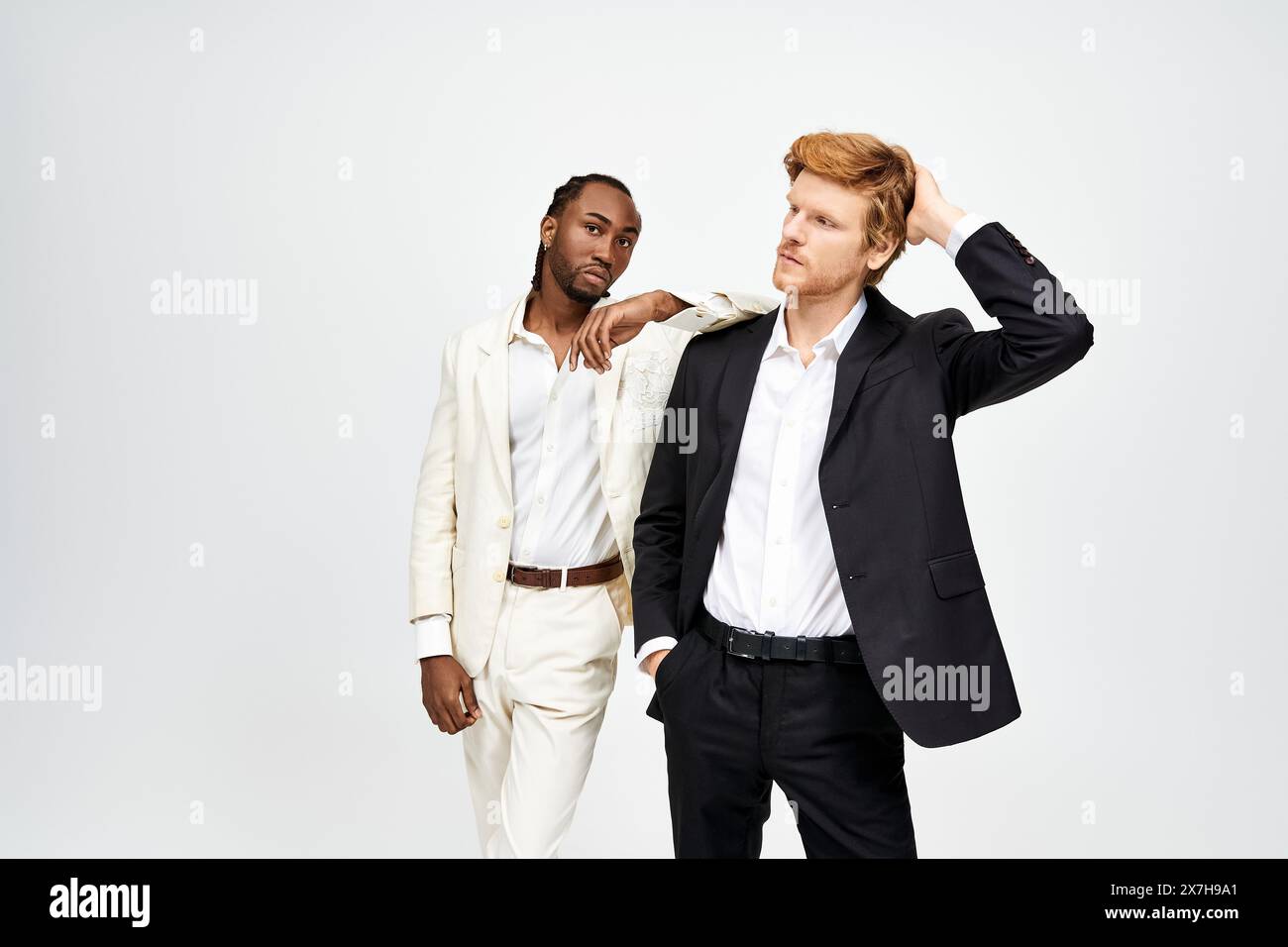 Two handsome multicultural men in elegant suits posing together Stock ...