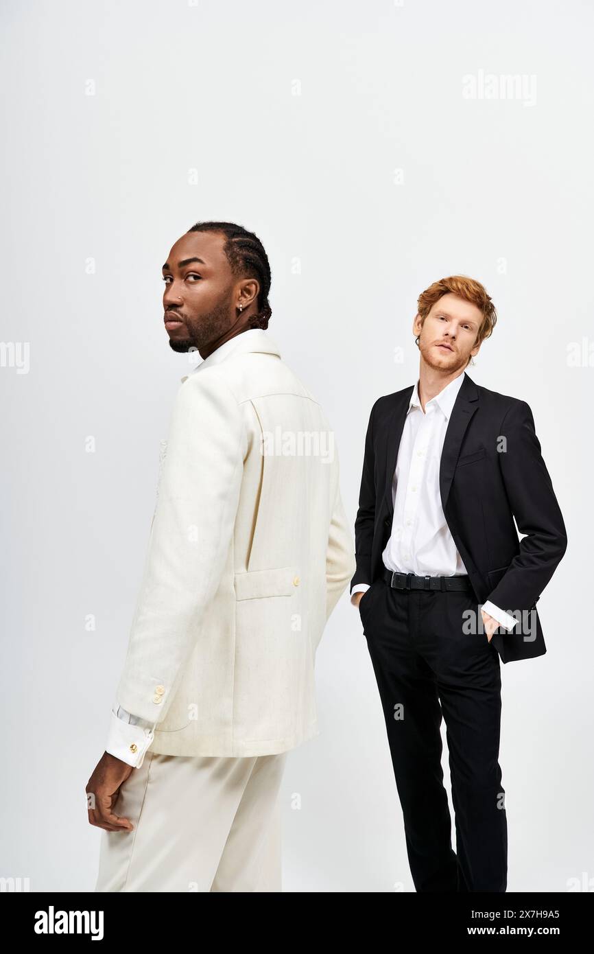 Two handsome men, one multicultural, stand elegantly in suits Stock ...
